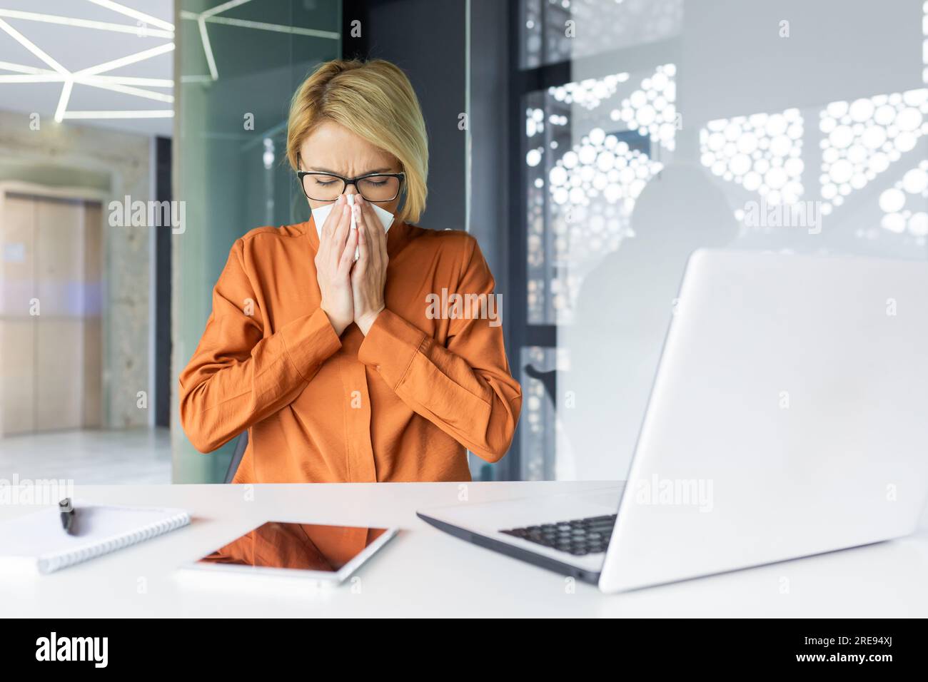 Sick woman at workplace works inside office, business woman has allergy ...