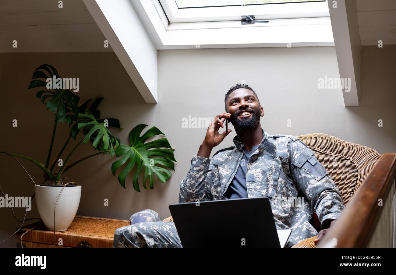 African american male soldier wearing military uniform with laptop and ...