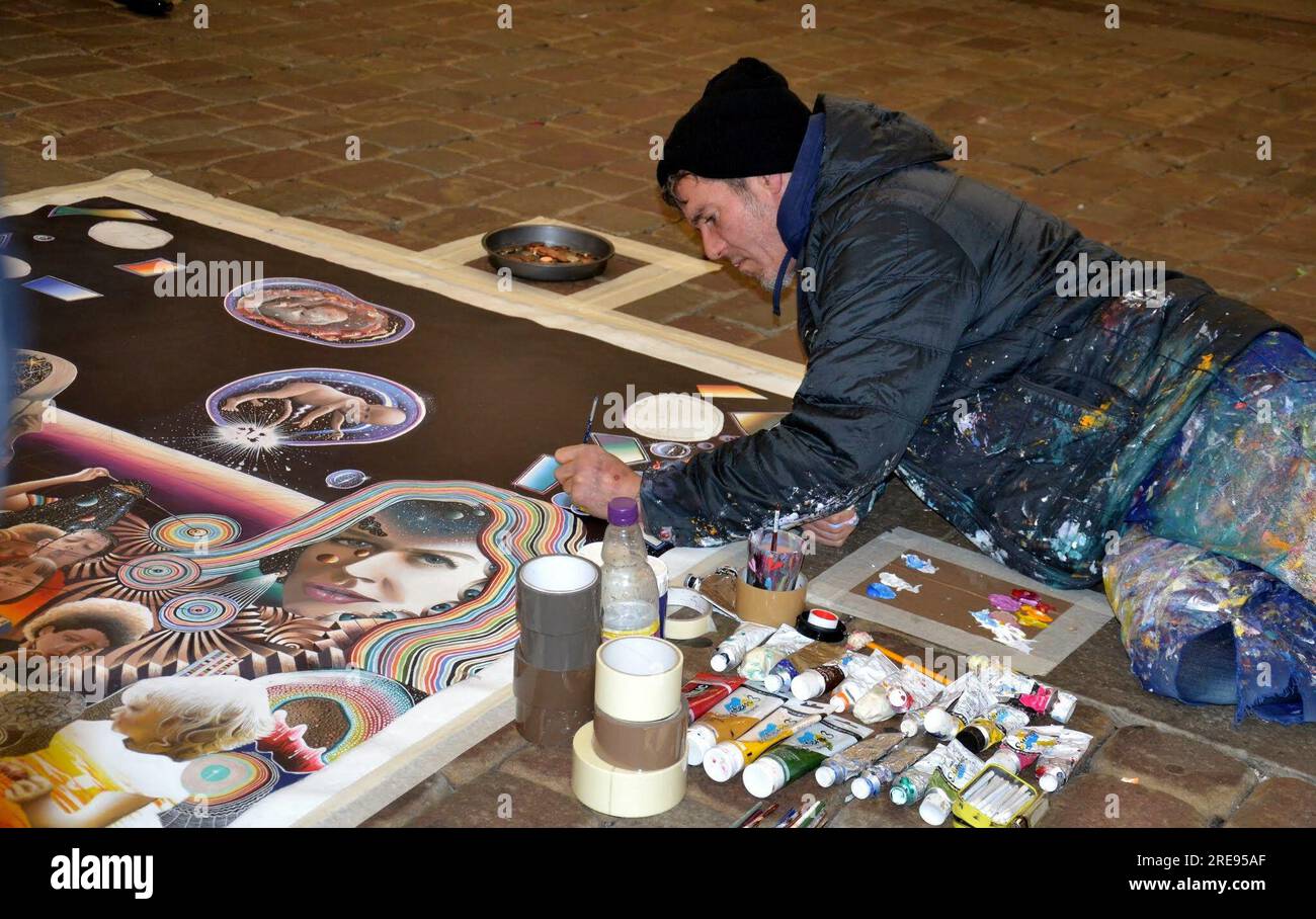 archival: street artist puts finishing touches to his paintings on ...