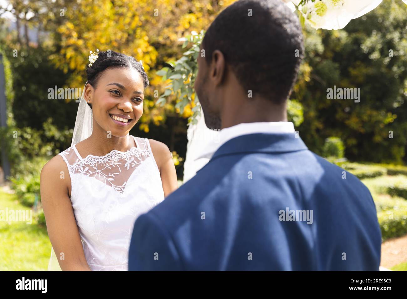 Happy african american bride and groom smiling at wedding ceremony in ...