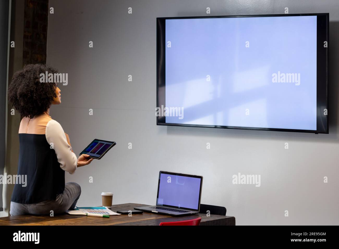 African american businesswoman with digital tablet having video call on ...