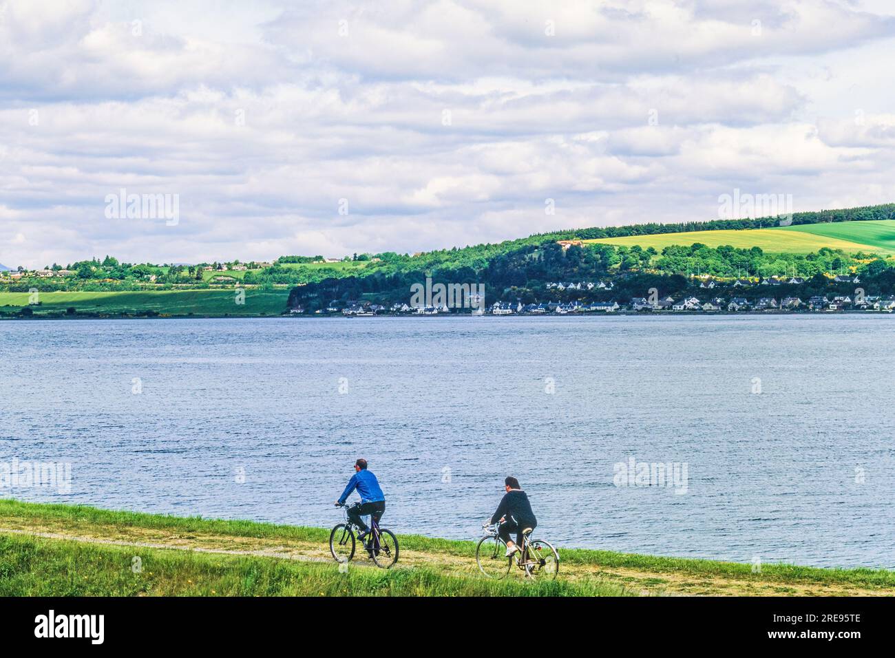 Couple cycling on a seaside path in Scotland Stock Photo - Alamy