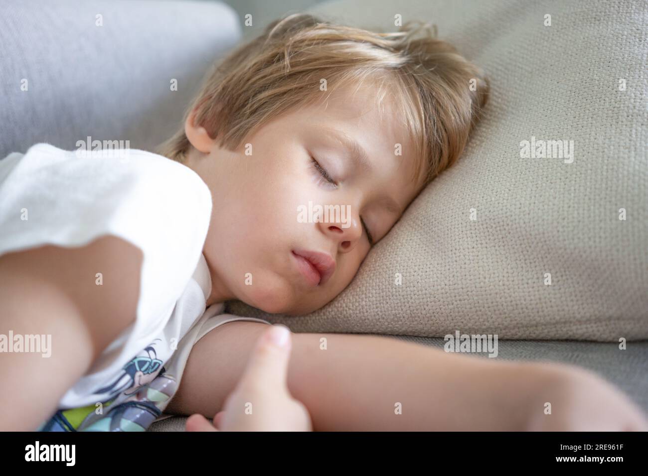 Little boy sleeping on the couch at home in the living room Stock Photo ...