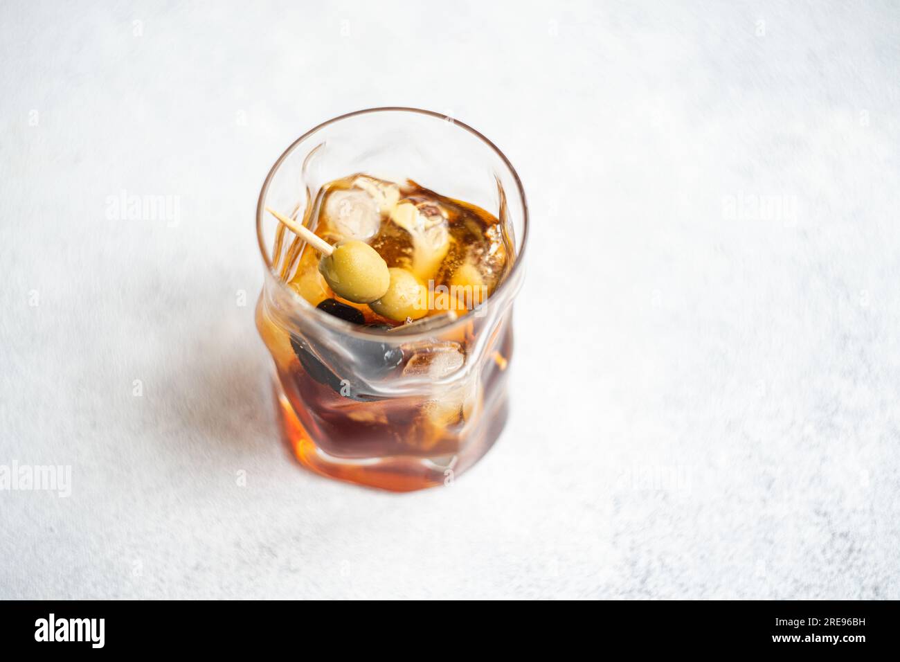 High angle of transparent glass cup with whiskey alcoholic drink and ...