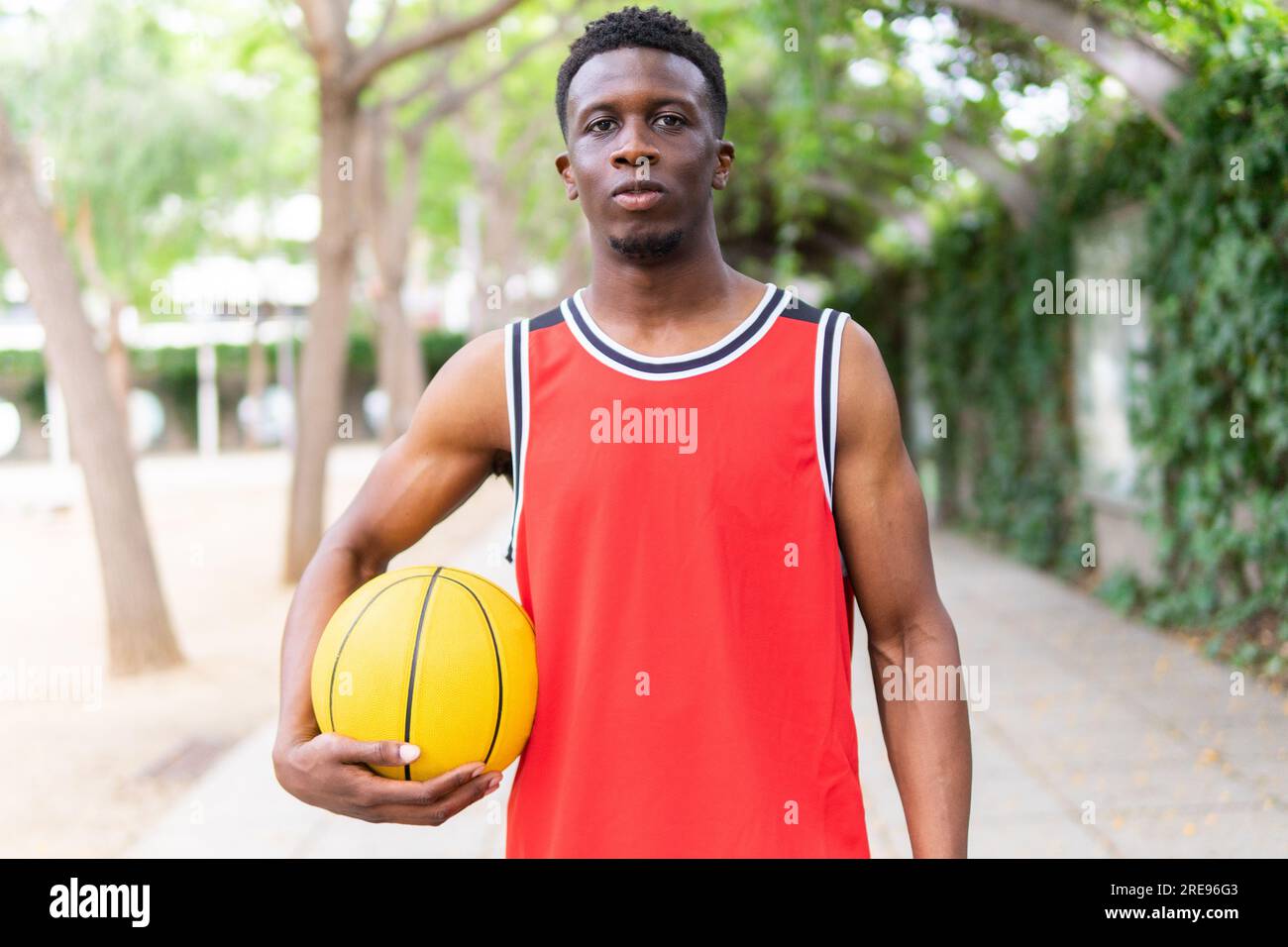 Portrait of confident young African American sportsman in activewear ...