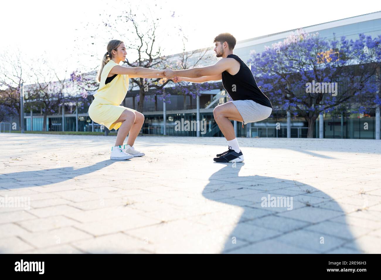 Full body side view of serious couple in sportswear and sneakers ...