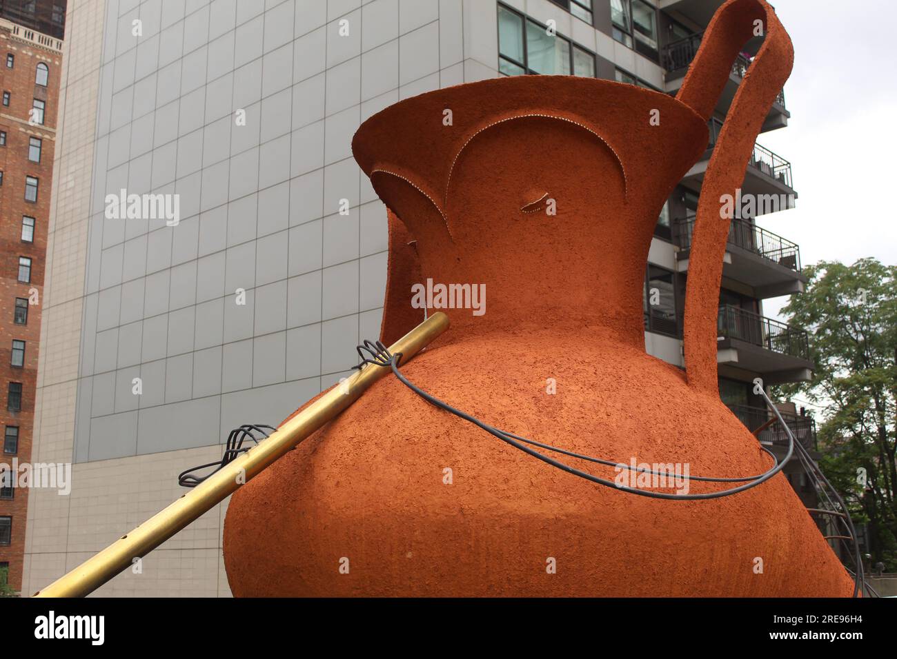 A photo of an orange statue on the High Line in New York City with a ...