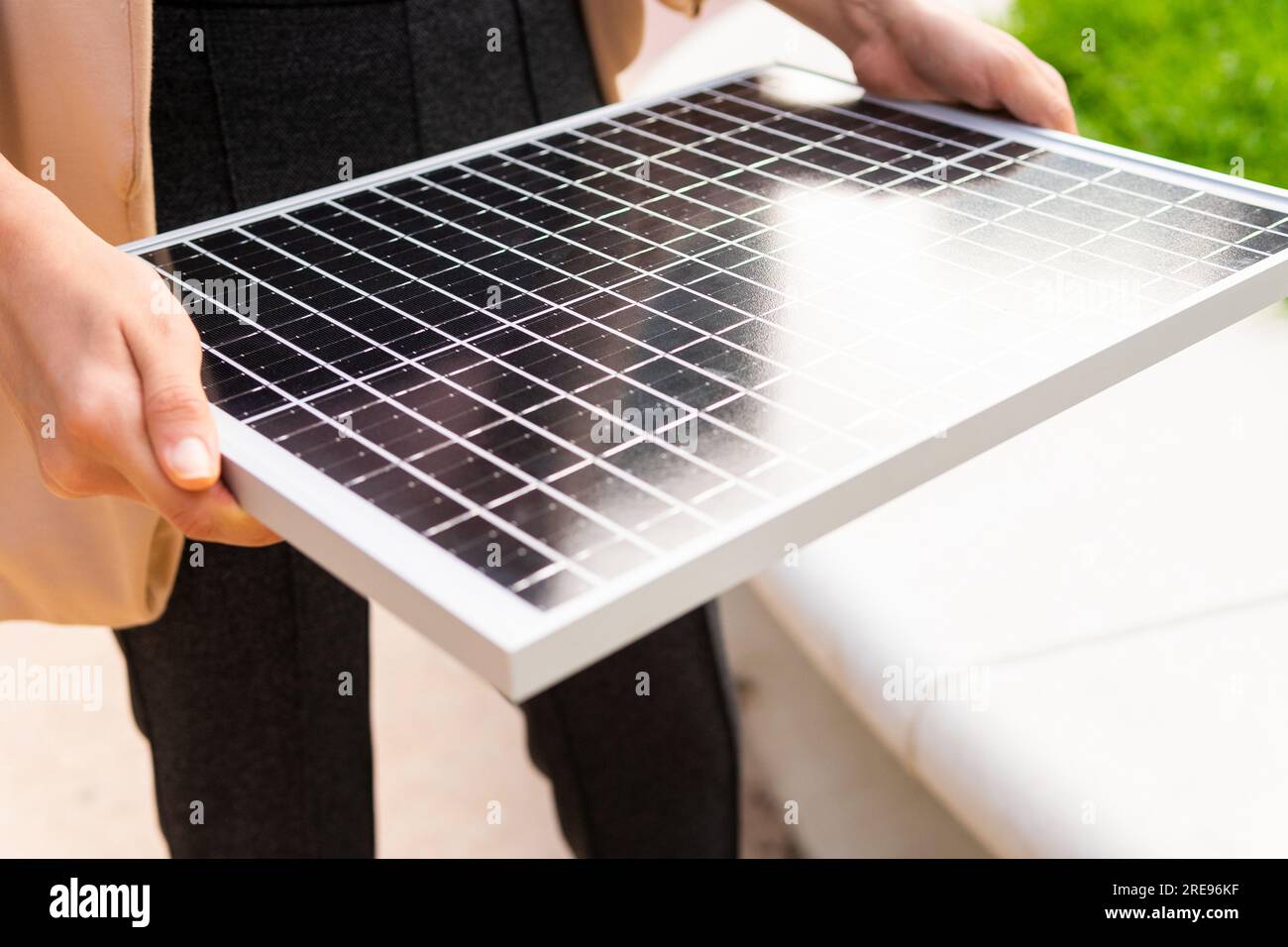 Crop anonymous female holding a portable solar battery reflecting ...
