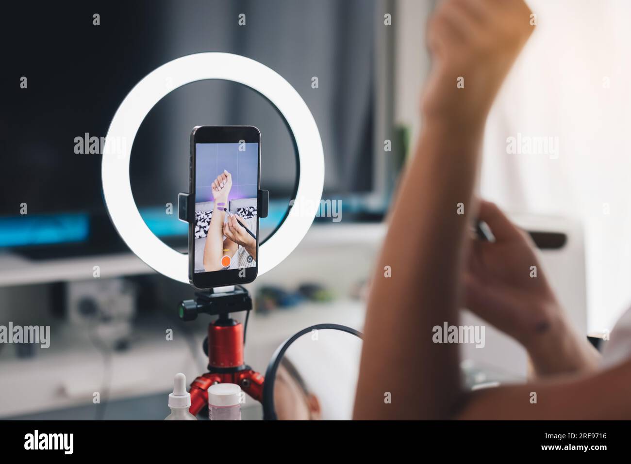 Crop anonymous female influencer shooting makeup tutorial via ...