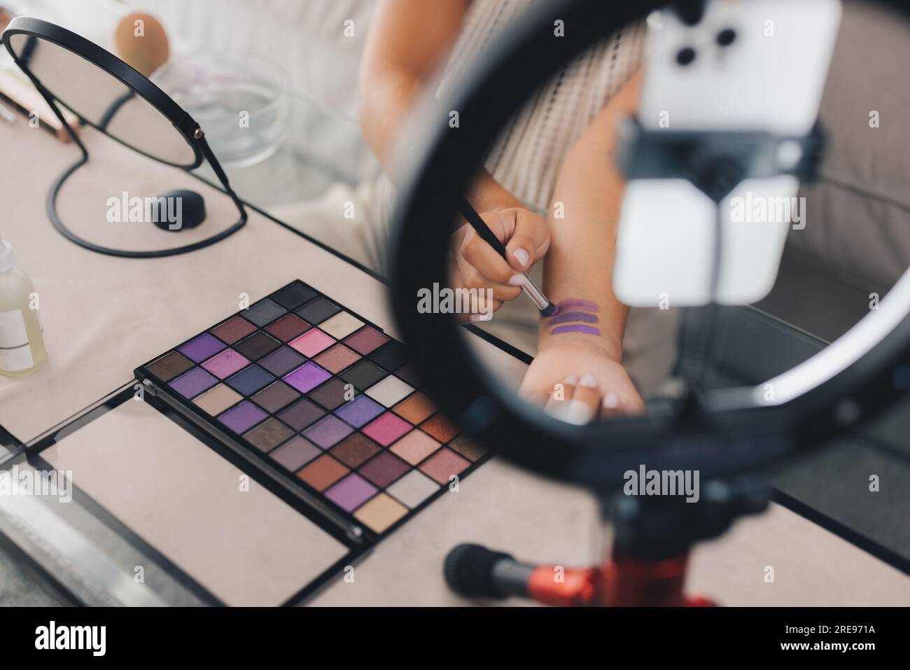 unrecognized woman influencer applying makeup at home. woman vlogger ...