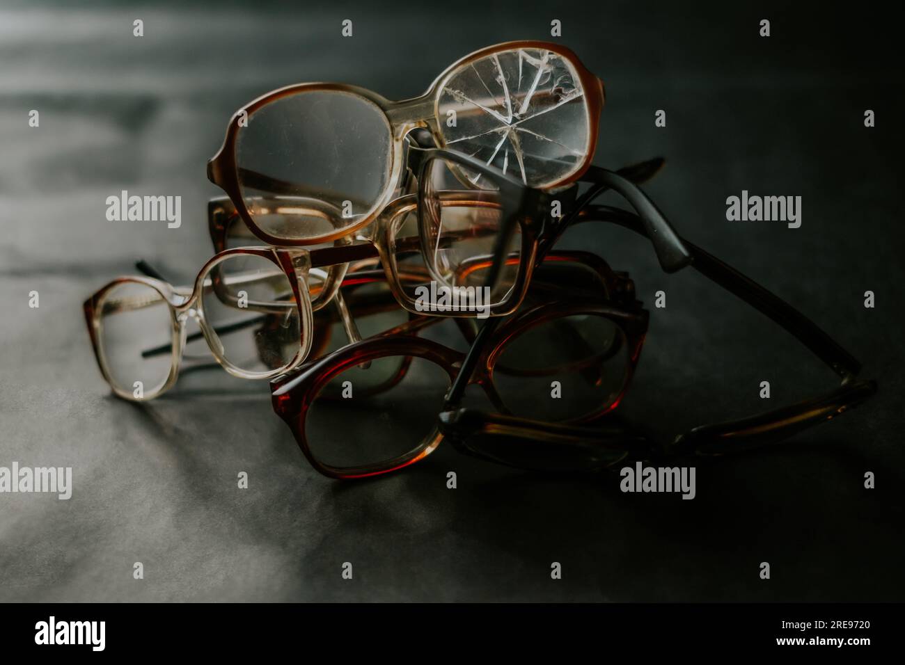 Focused of stack of broken stylish eyeglasses with plastic rim and ...