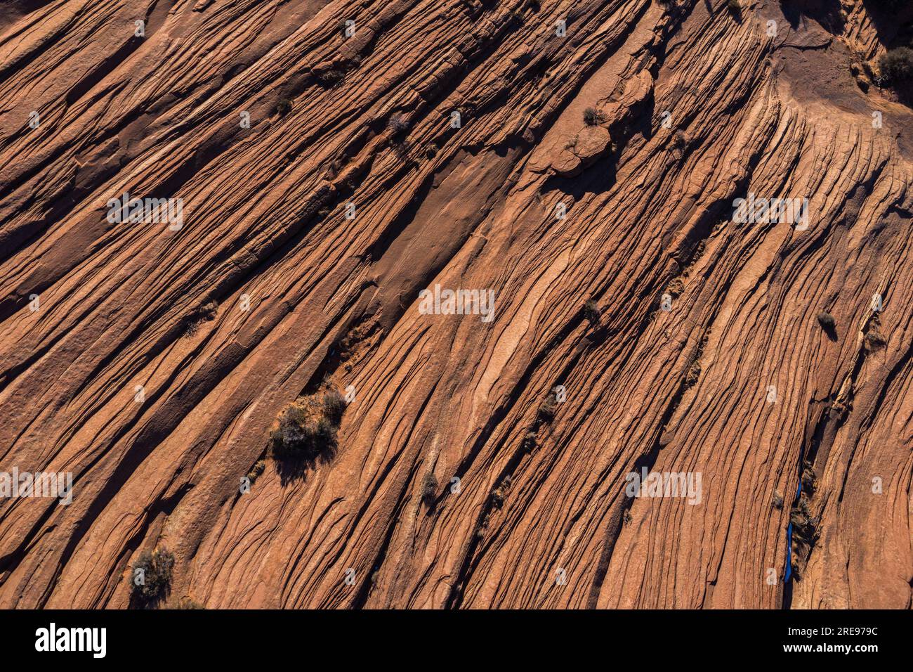From above rough textured surface of sandstone cliff with cracks and ...