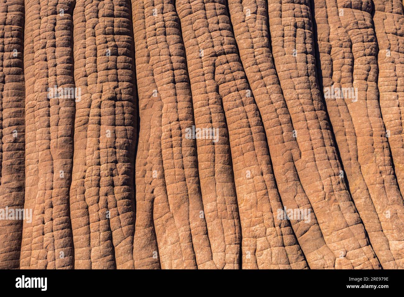 From above rough textured surface of sandstone cliff with cracks and ...