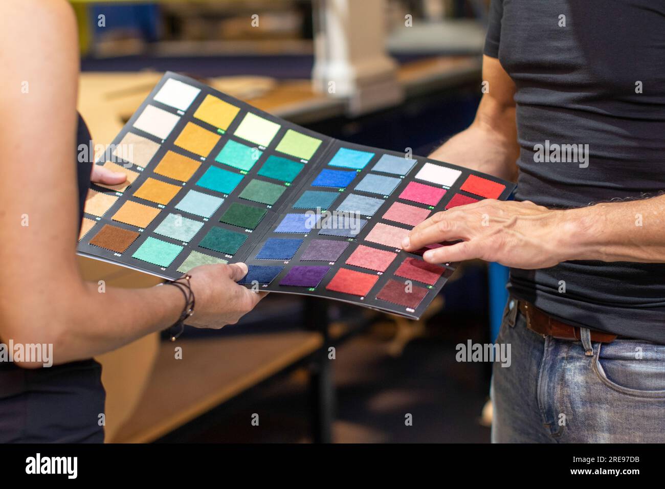 Crop anonymous male in casual clothes standing and touching with finger ...