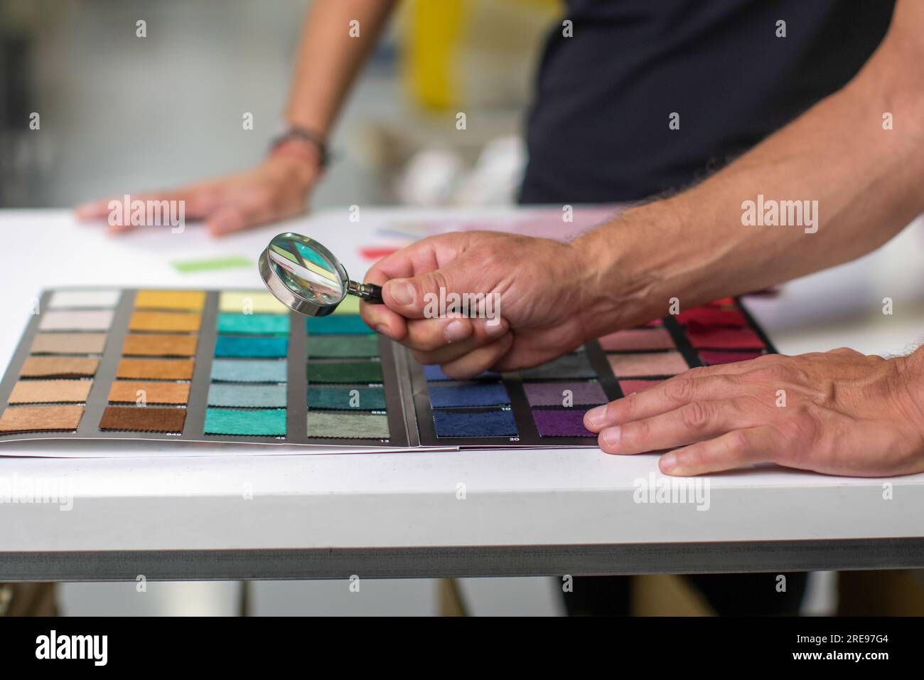 Side view of anonymous male worker using magnifying glass while ...