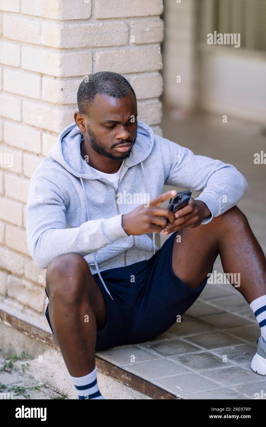 Side view of focused young African American male in sportswear and ...