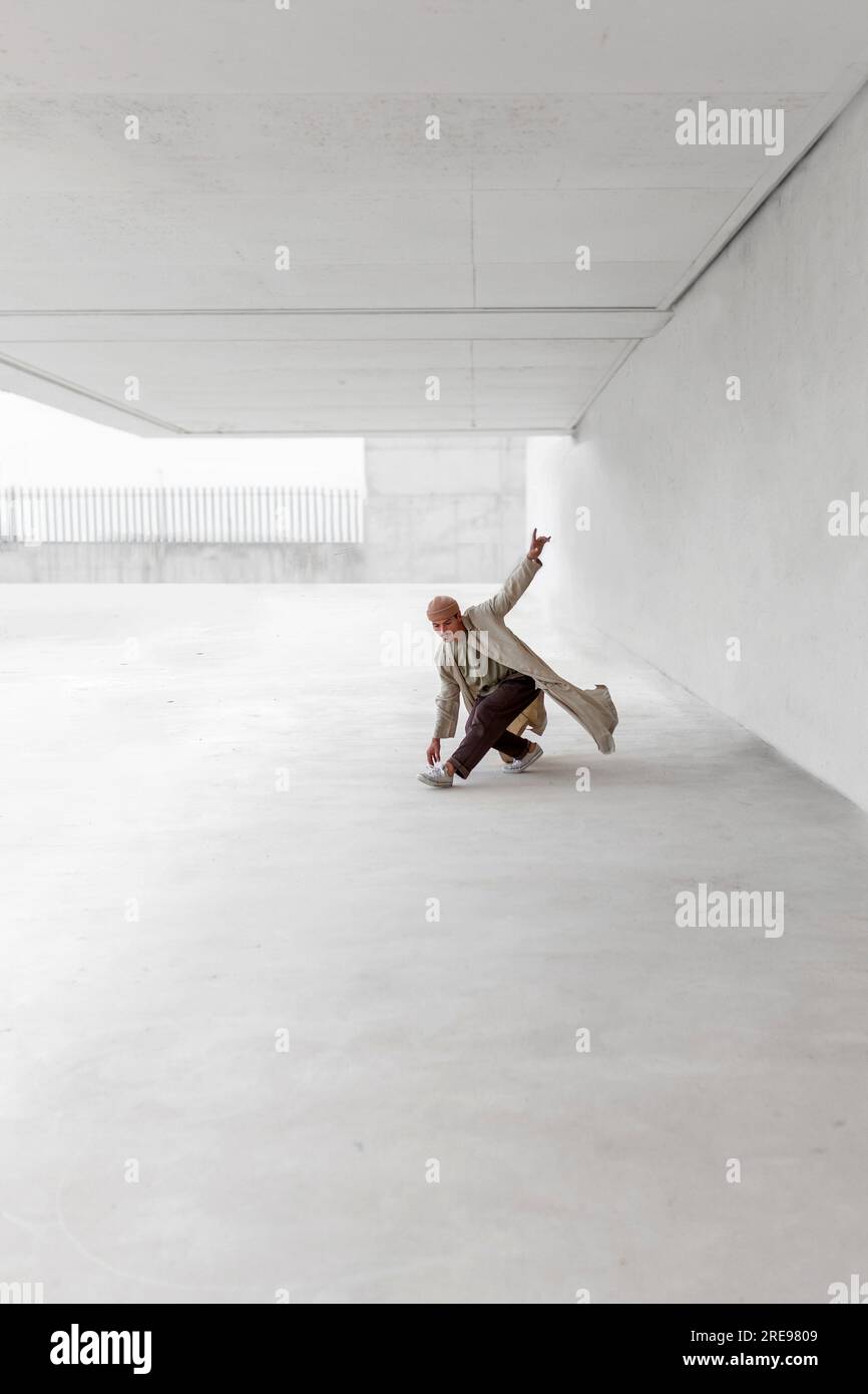 Male dancer showing breakdance movement while balancing on arms and ...