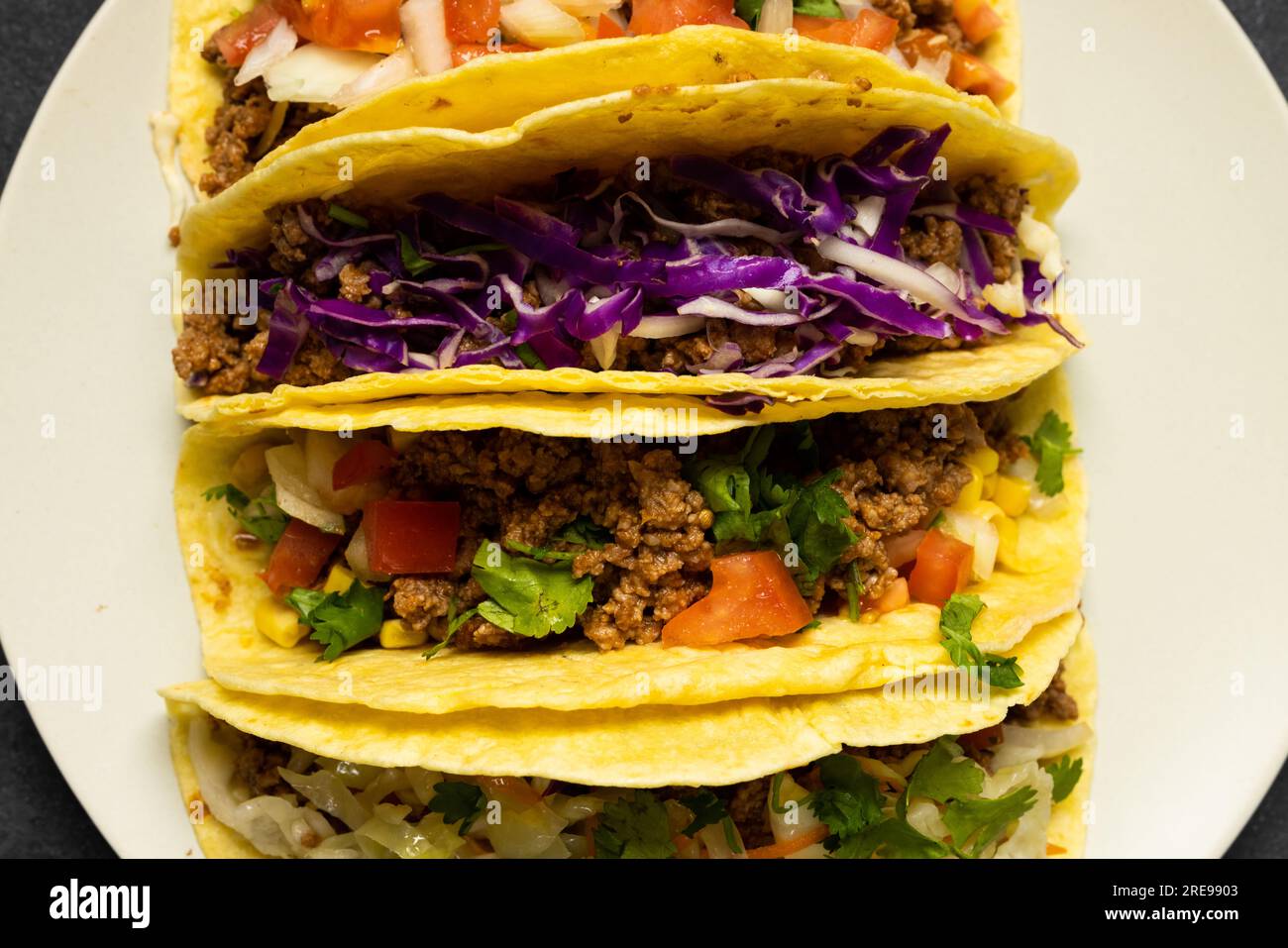 Overhead close-up of tacos made with meat and vegetables served in ...