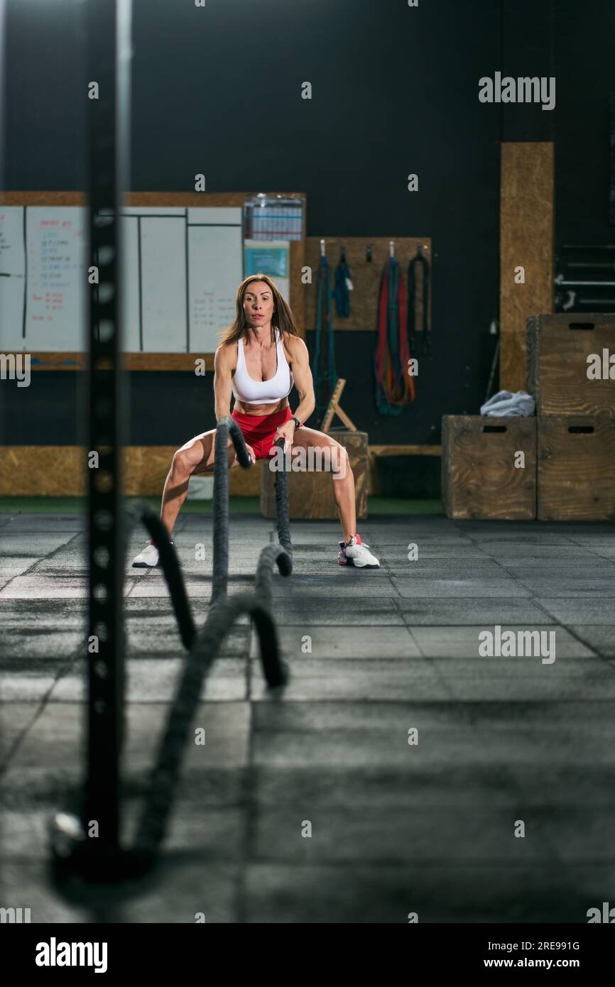 Full body of fit sportive female athlete in activewear doing exercise ...