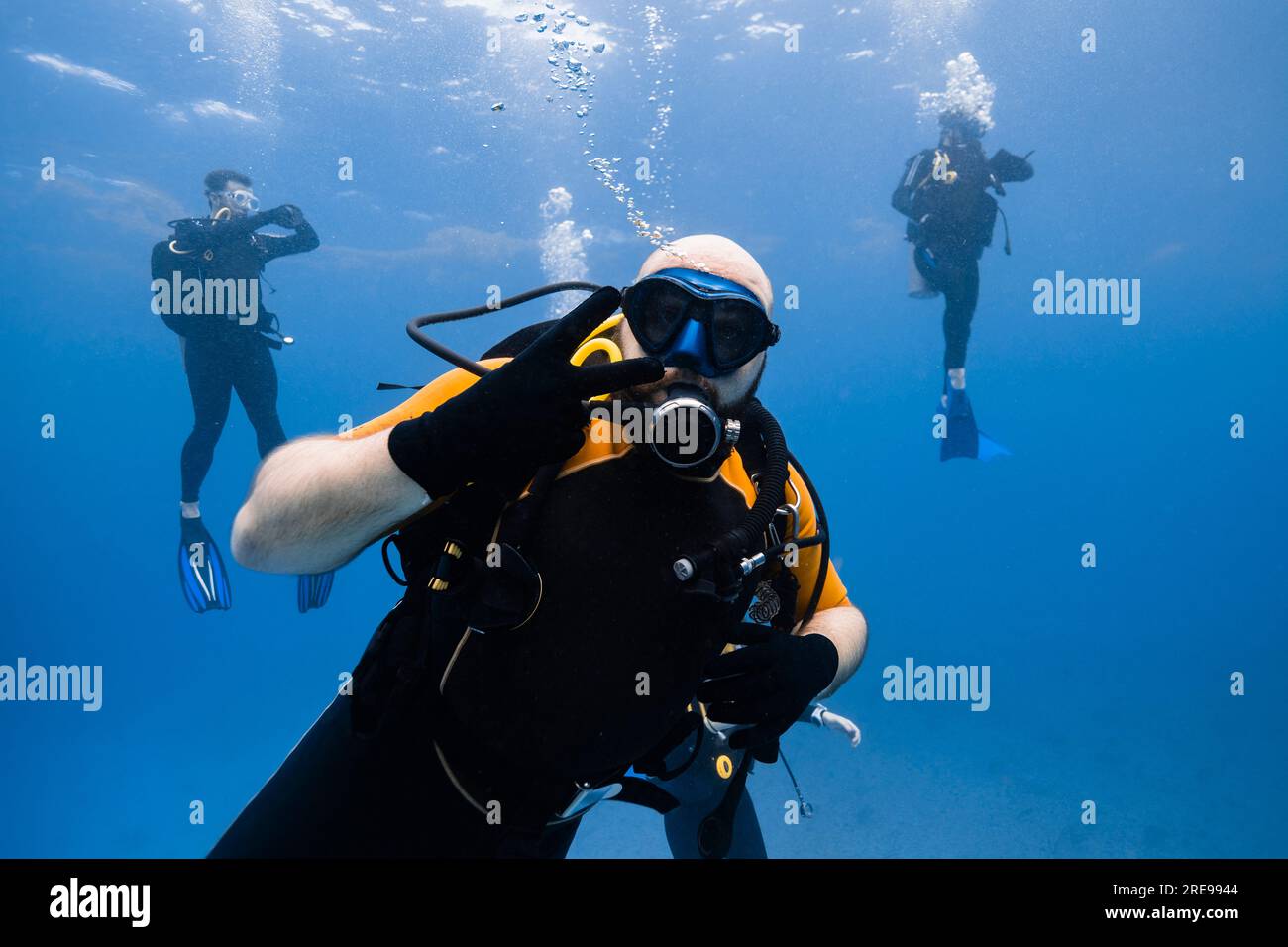 Scuba diver swimming underwater with bubbles while exploring deep clear ...