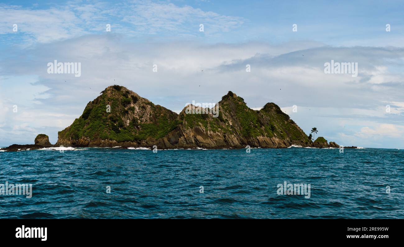 Picturesque scenery of rocky cliffs covered with greenery washed by ...