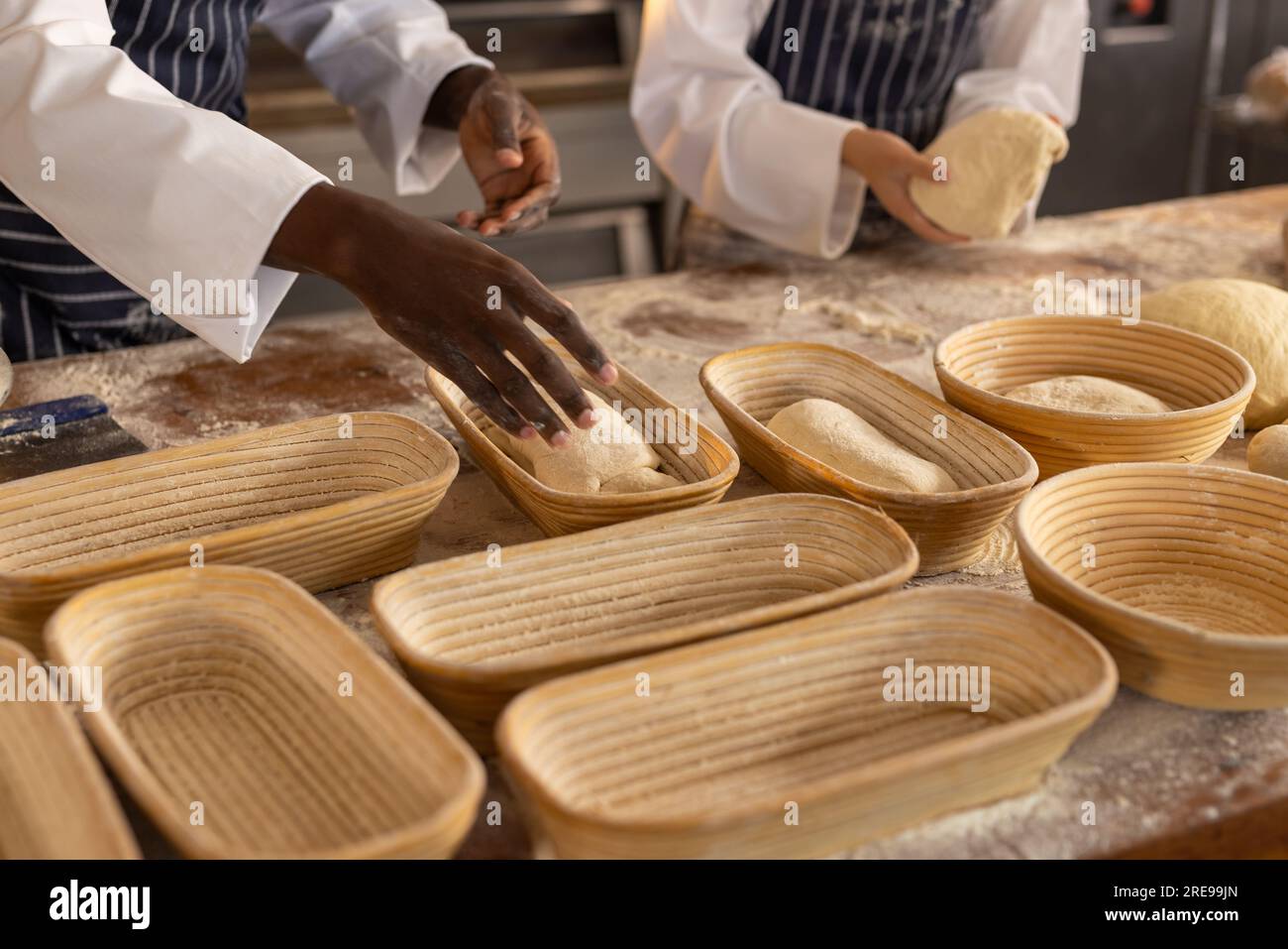 Baker putting dough basket hi-res stock photography and images - Alamy