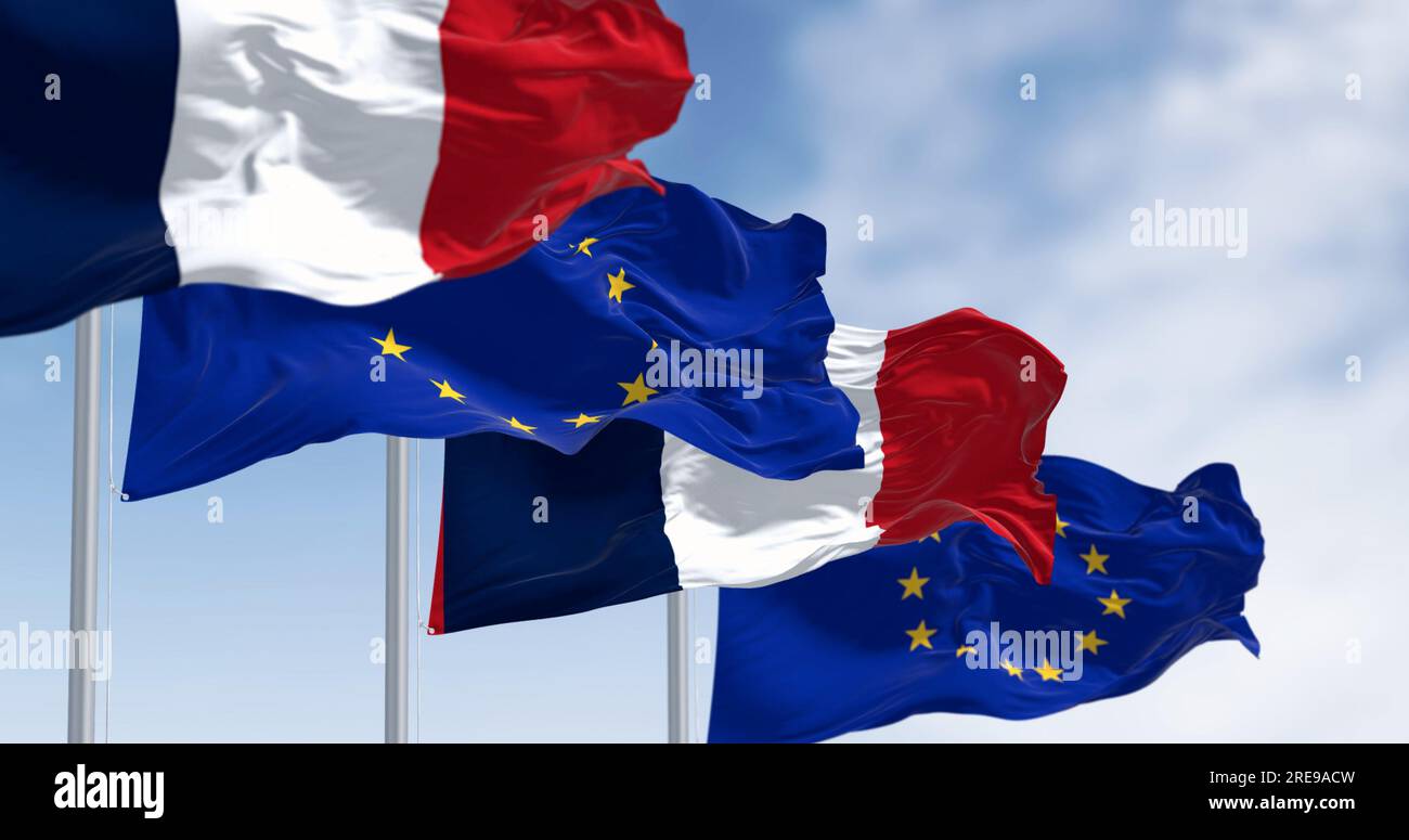 Flags of France and the European Union waving together on a clear day ...
