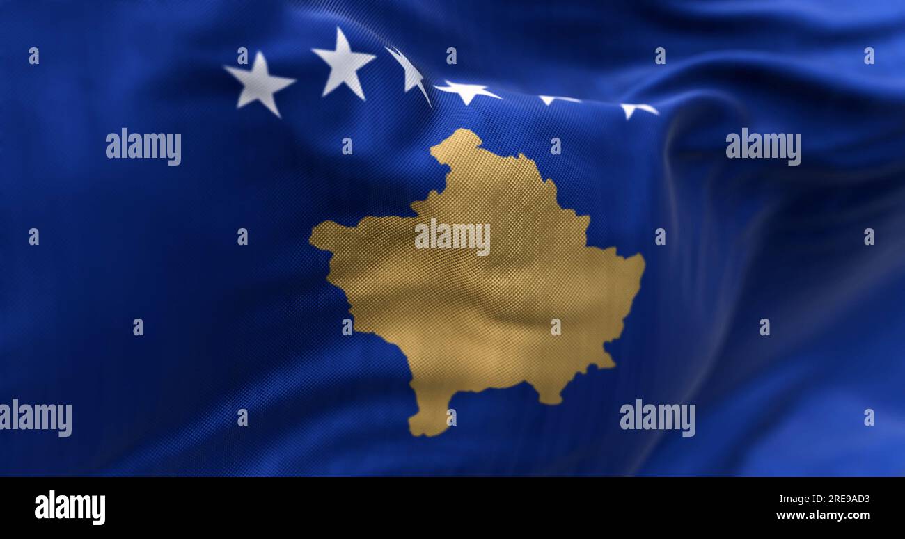 National flag of Kosovo waving in the wind on a clear day. Blue with a ...