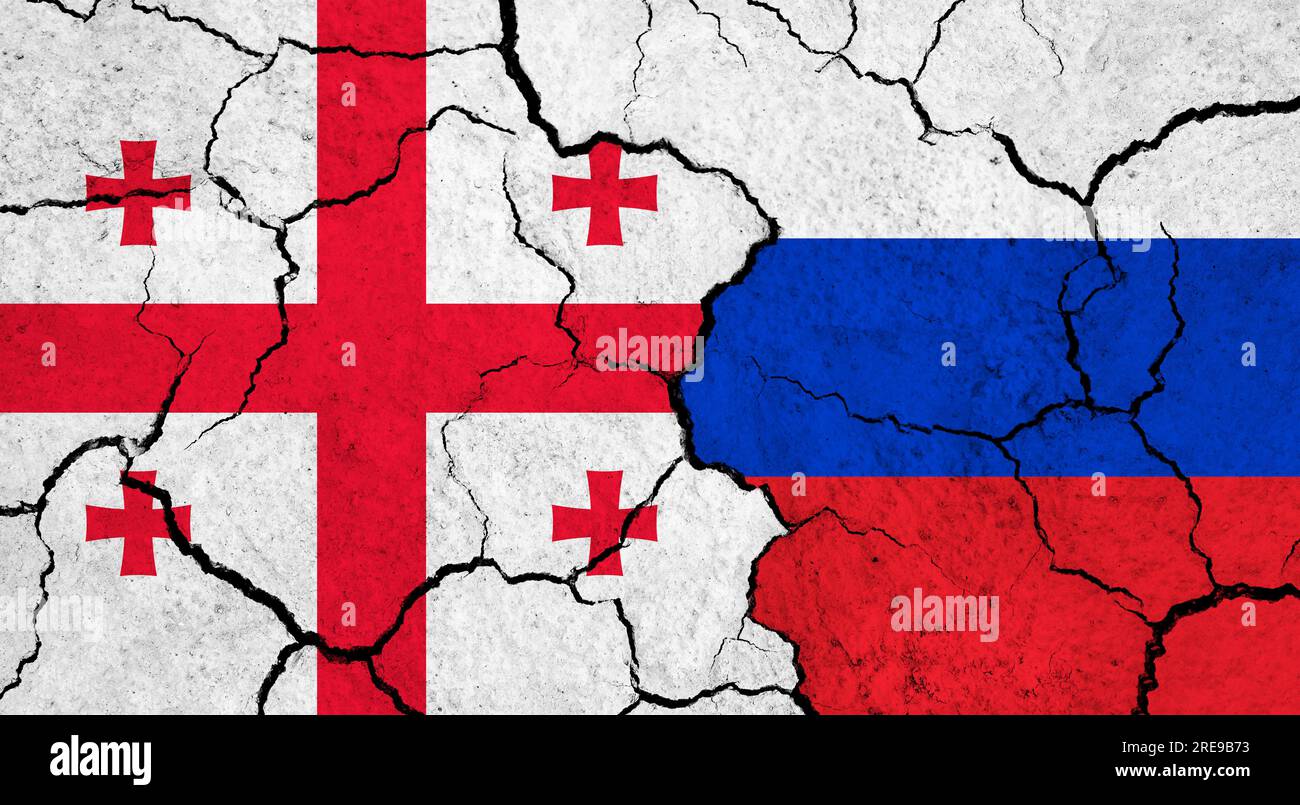 Flags of Georgia and Russia on cracked surface - politics, relationship ...