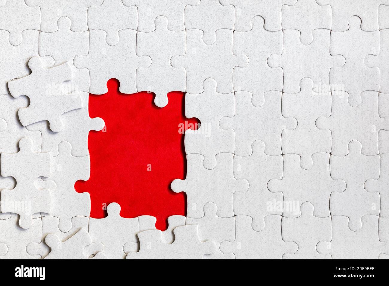 Unfinished white jigsaw puzzle pieces. Fill in pieces of the jigsaw ...