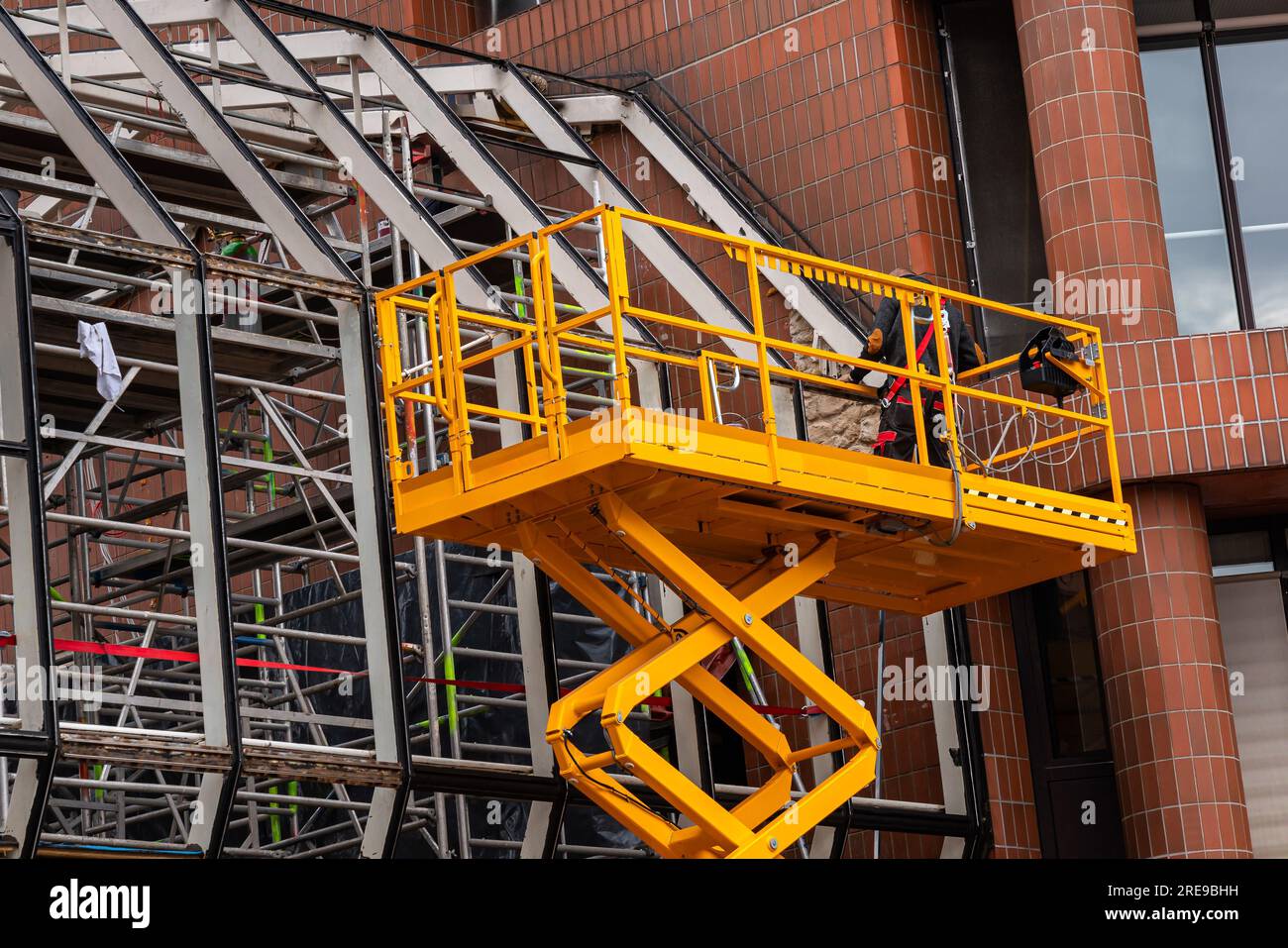 Yellow hydraulic lifting platform with bucket cabin on a telescopic ...