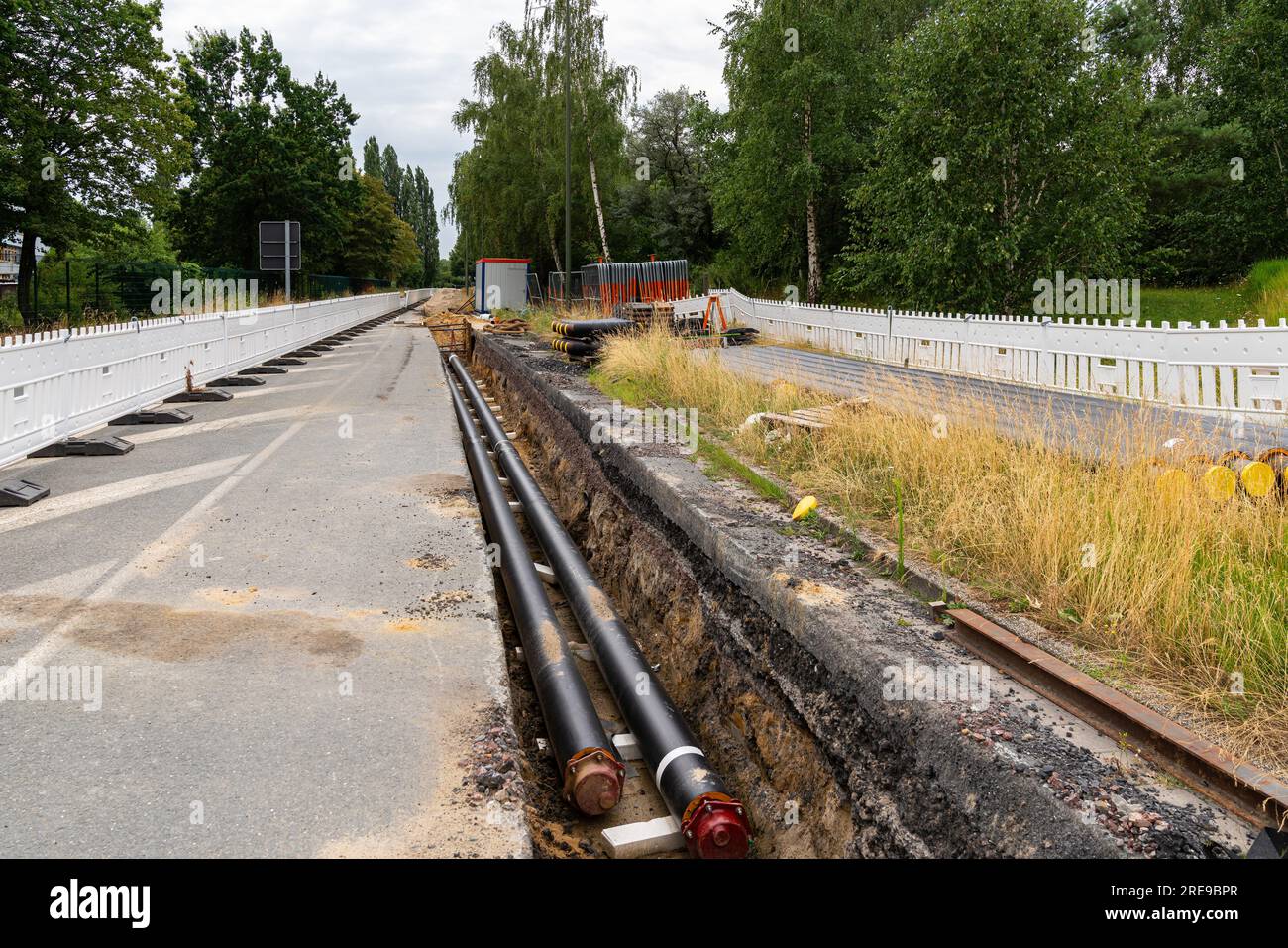Fenced with plastic barriers construction site with a black steel pipes ...
