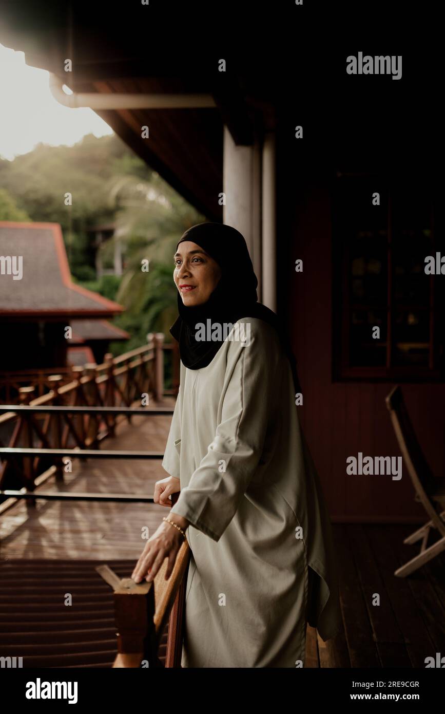 Portrait of a women sitting by the window Stock Photo - Alamy