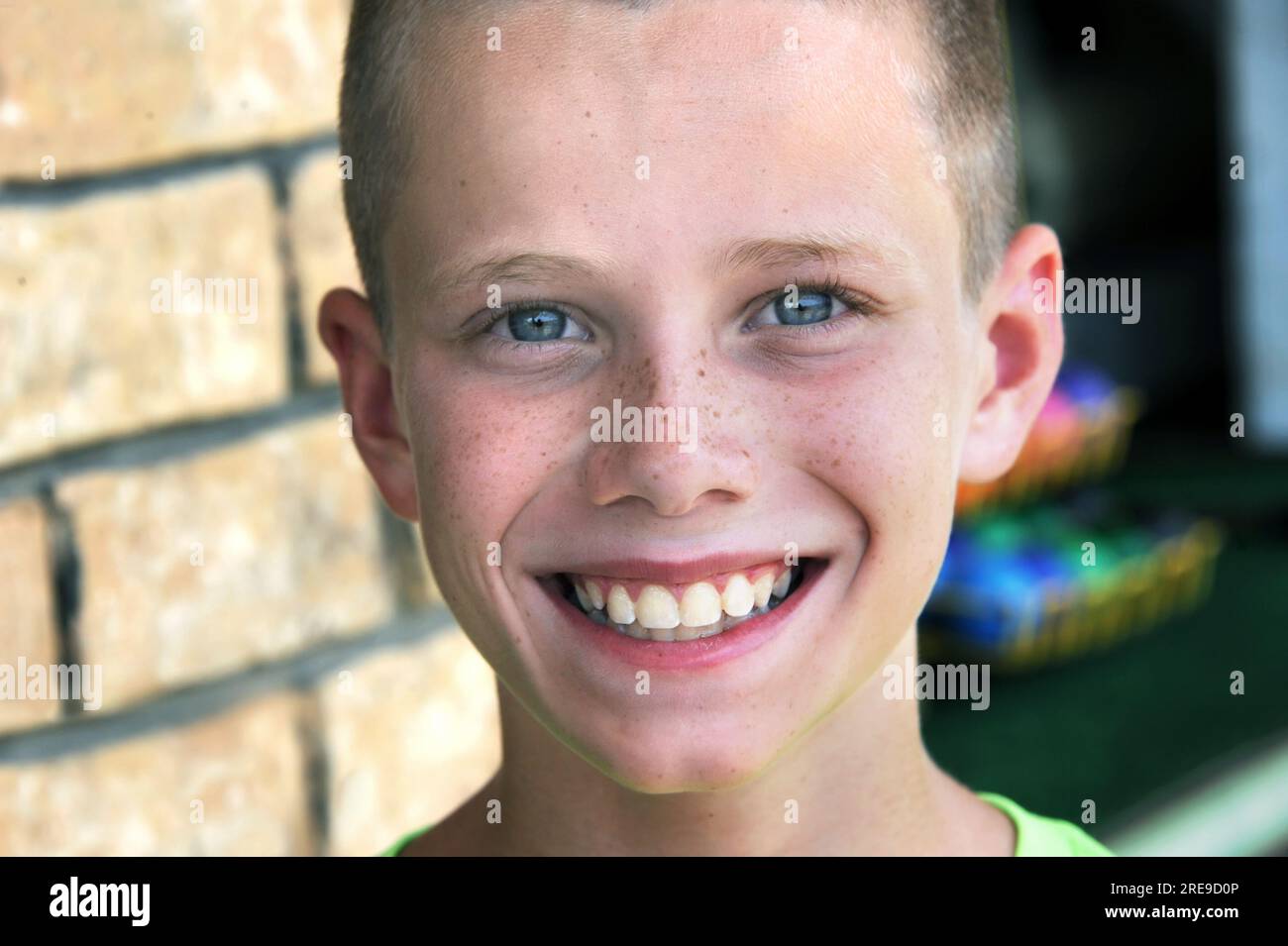 Young boy grins as he begins a round of put-put golf. Closeup shows he ...