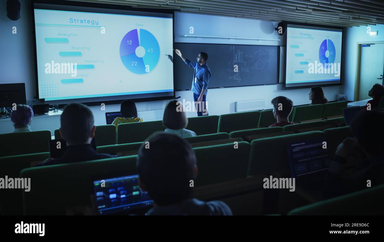 Young Male Teacher Giving a Data Science Lecture to a Diverse ...