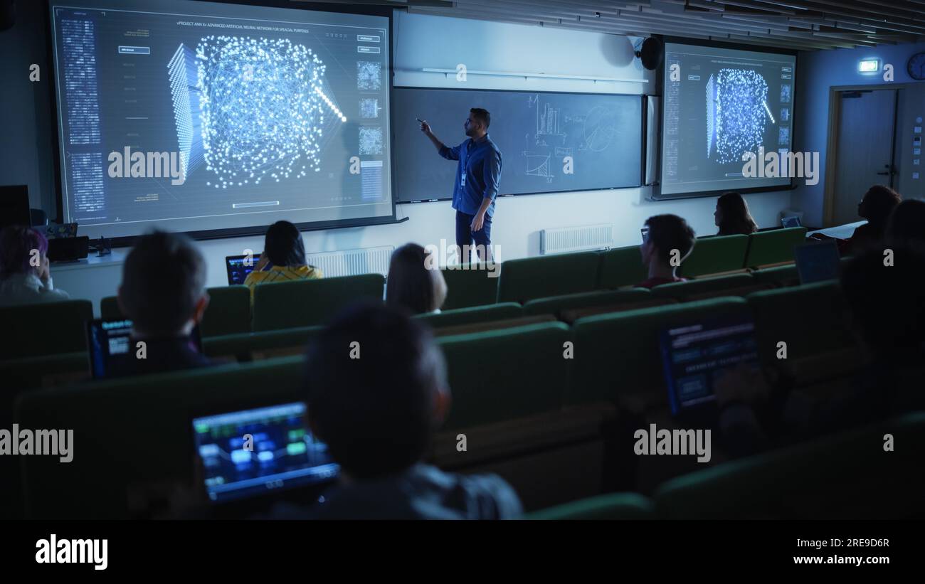 Young Male Teacher Giving a Data Science Lecture to a Diverse Multiethnic Group of Female and ...