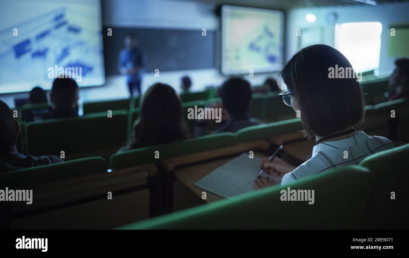 Over the Shoulder Footage of a Female Student Taking Down Notes in a ...