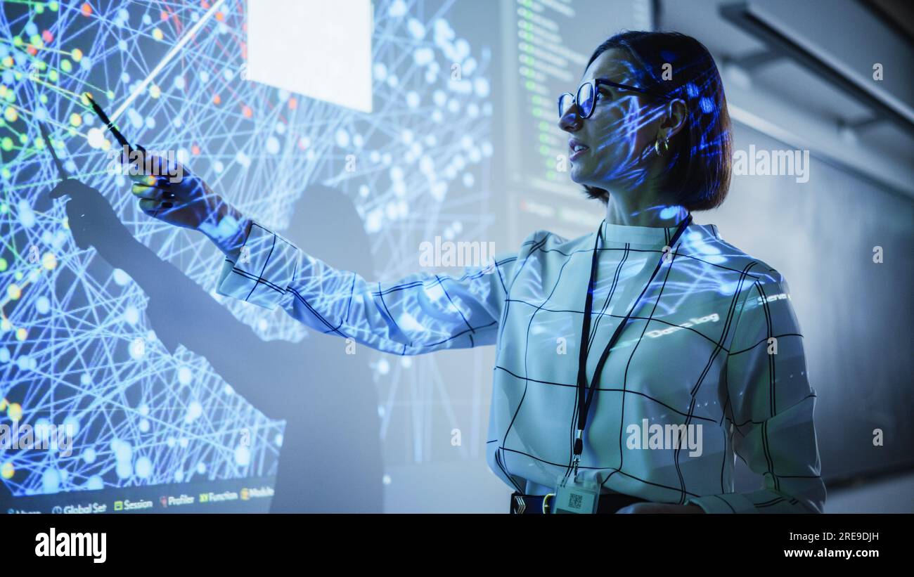 Young Female Teacher Giving a Data Science Lecture to Diverse ...