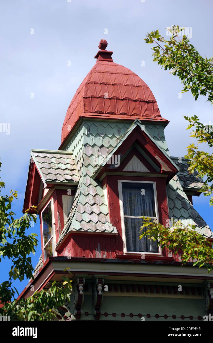 Queen Ann Victorian home has square turret with dome top. Wooden ...