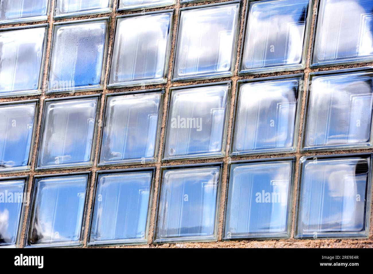 Background image shows sky reflected in rectangle panes of glass ...