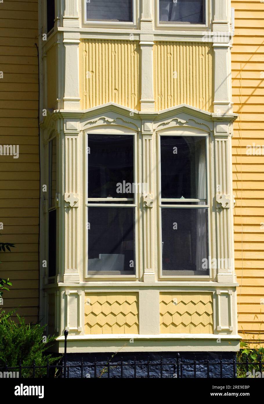 Beautifuly trimmed, double windows on Victorian home are painted in ...