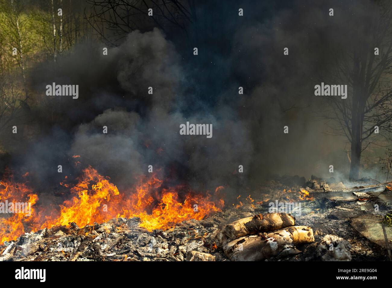 Fire in landfill. Fire and smoke. Burning garbage. Lots of black smoke ...