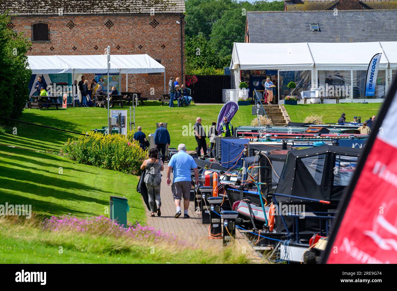 Visitors to a boat exhibition held in an inland waterways marina with ...