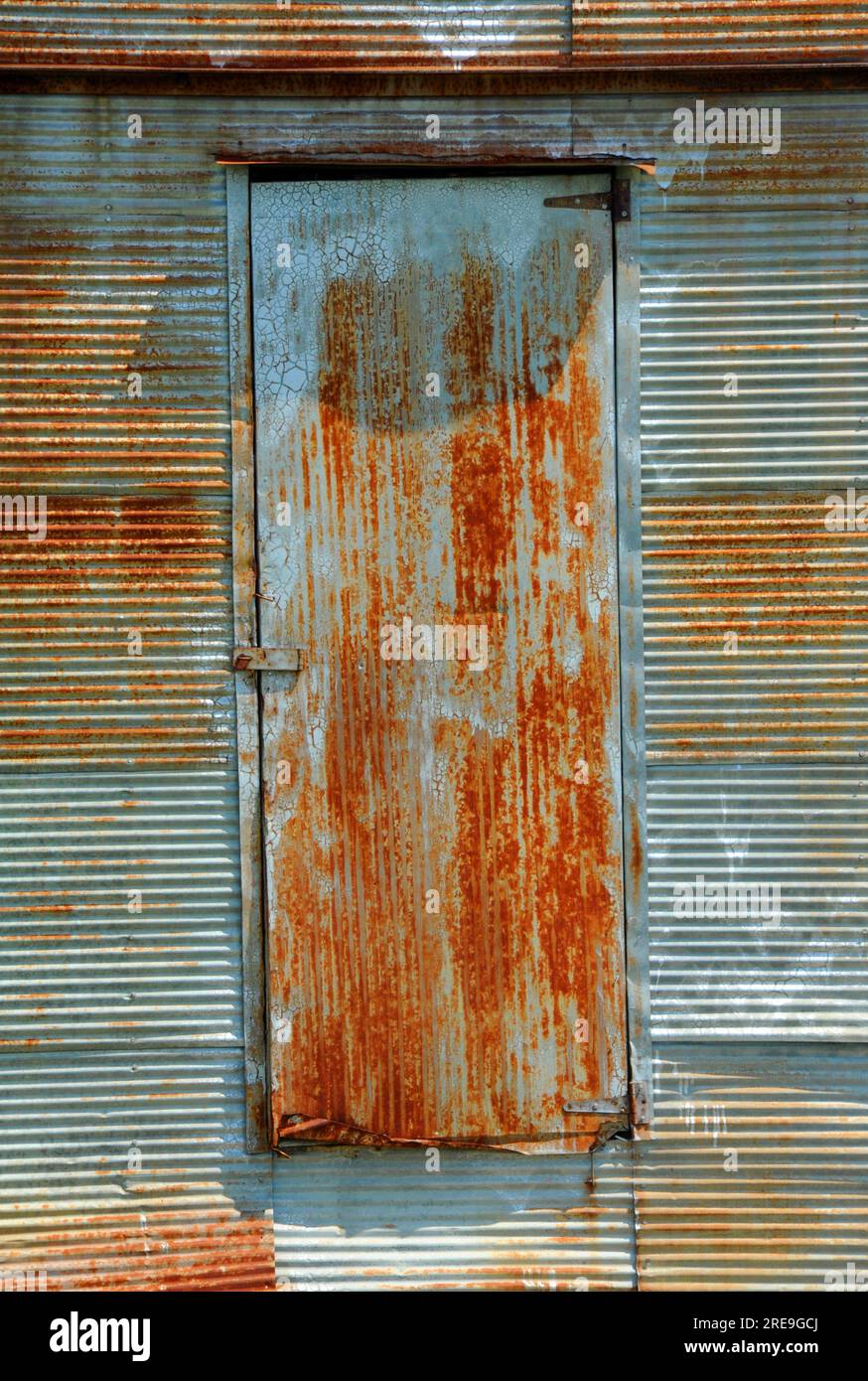 Tin door and building is rusting. Siding and door is corrugated tin ...