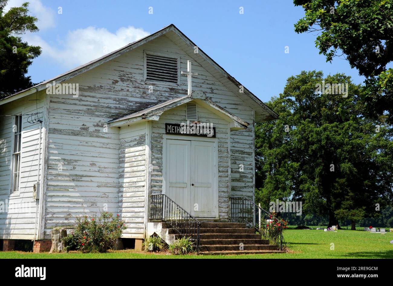Old country, methodist church sits besides a graveyard. Building has ...