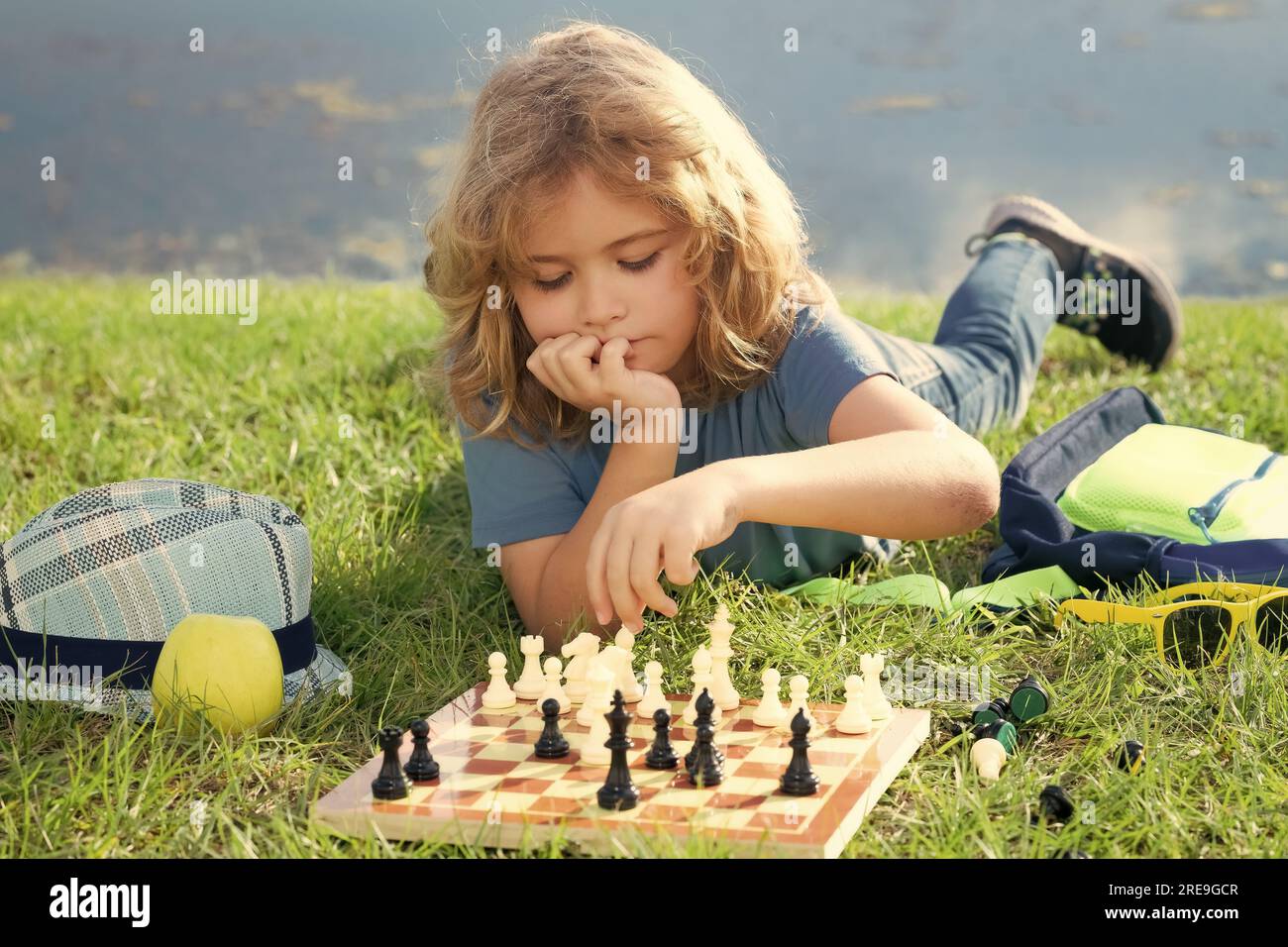 Clever concentrated and thinking kid boy playing chess Stock Photo - Alamy