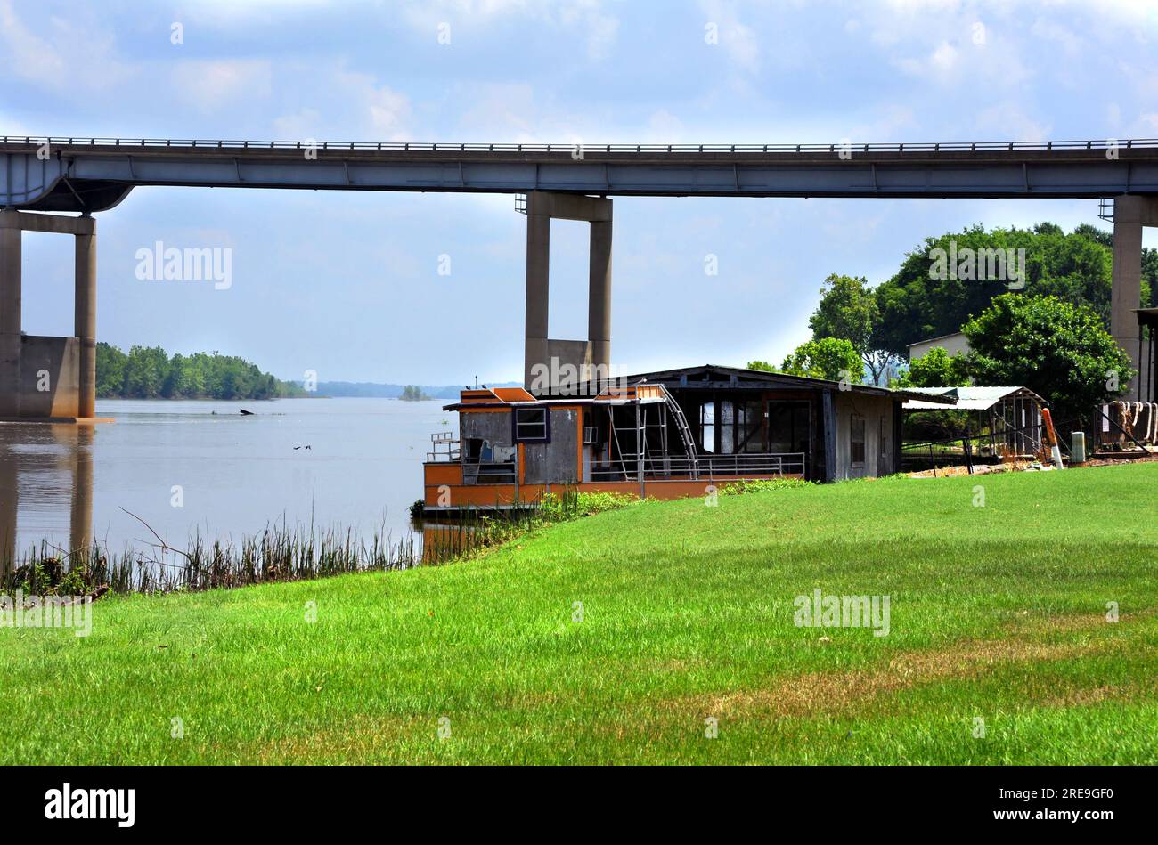 Houseboat sits rotting and abandoned on the bank of the Arkansas River ...