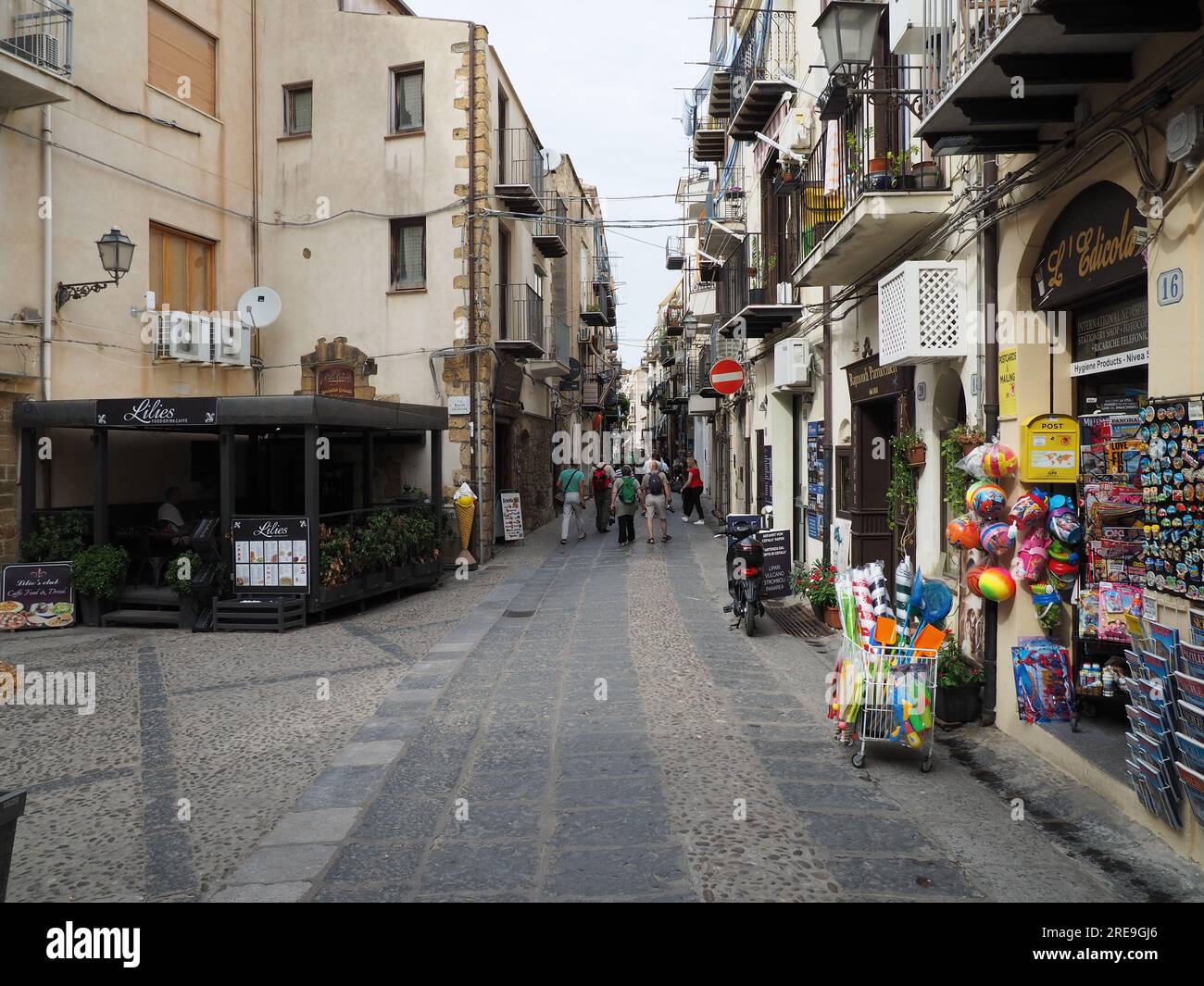 Street scene in Cefalu, northern Sicily with tourists and tourist shops ...