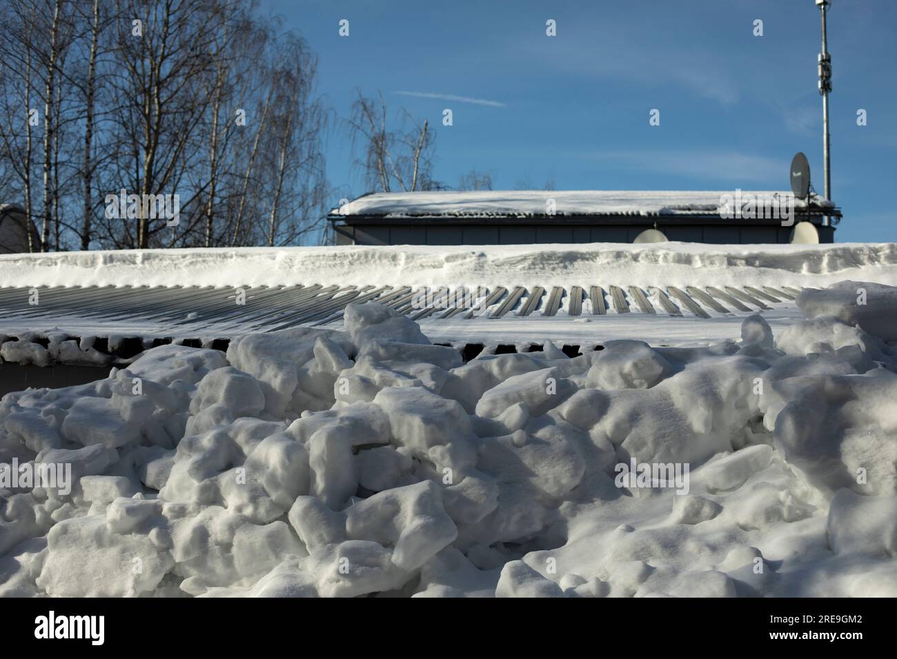 Snow on roof. Snow removal from roof of house. Large clumps of ice ...