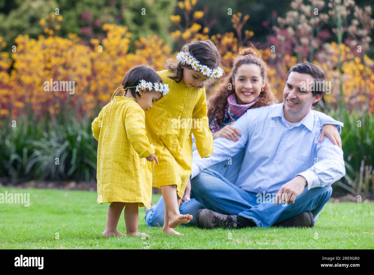 Family of four having fun outdoors in a beautiful sunny day at the park ...